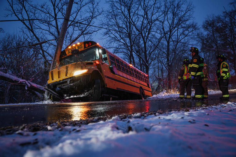 Suburban school bus crash on snowy road downs power lines, leaves 1 ...