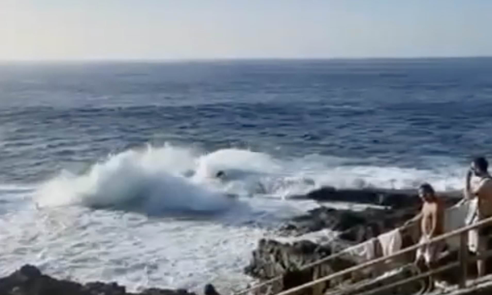 Waves smash natural pool seconds before four tourists are swept to ...