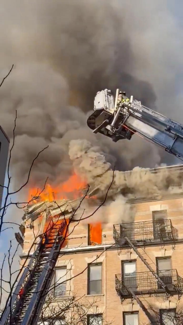 Flames erupt from windows, roof as blaze engulfs NYC apartment building