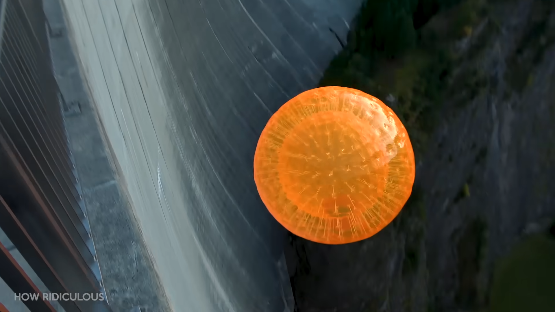How far this giant ball can travel when launched off a 550 feet cliff
