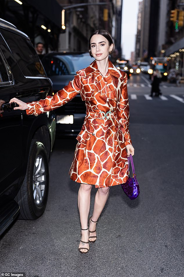 Lily Collins cuts a stylish figure in a vintage Roberto Cavalli coat as ...