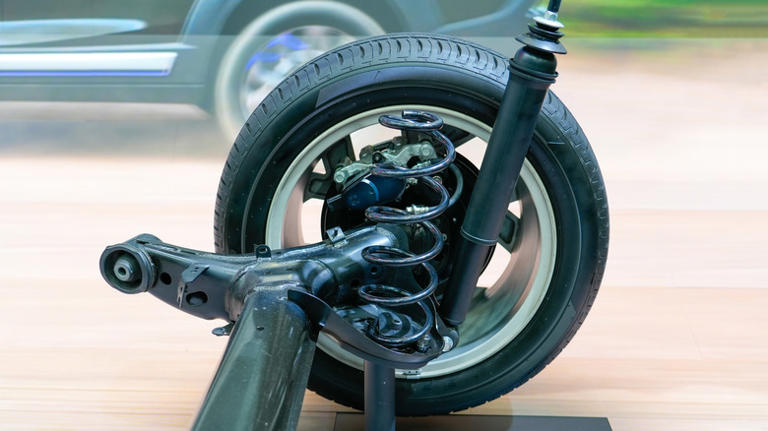 What are the pros and cons of a torsion beam suspension?