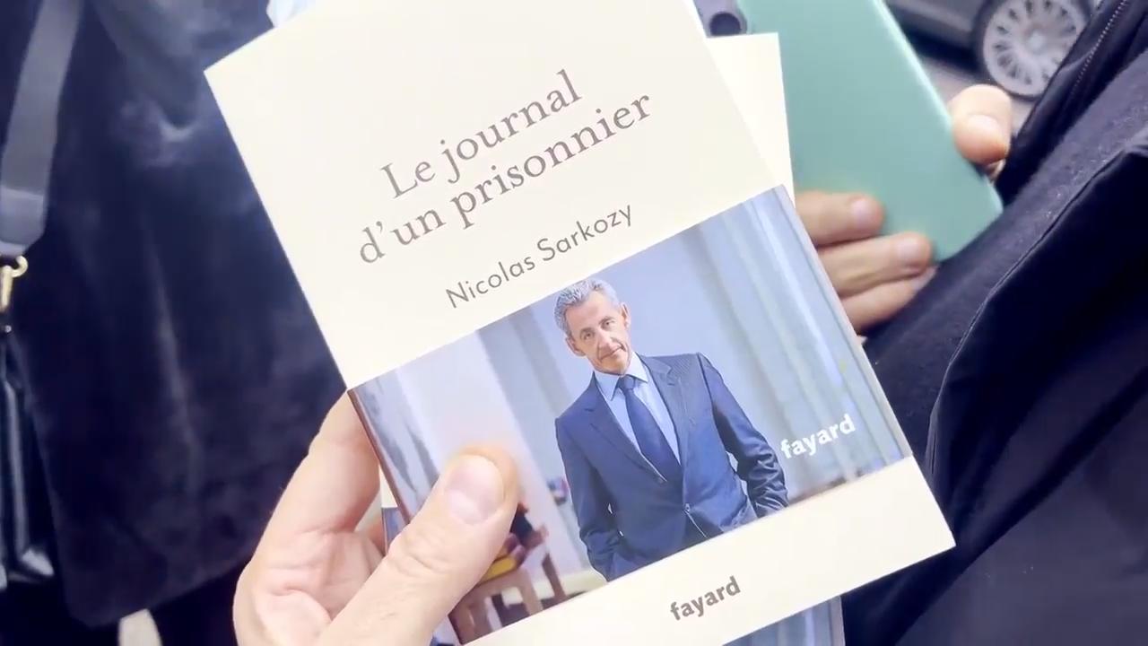 Crowd queues down Paris street as Sarkozy holds book signing for prison ...