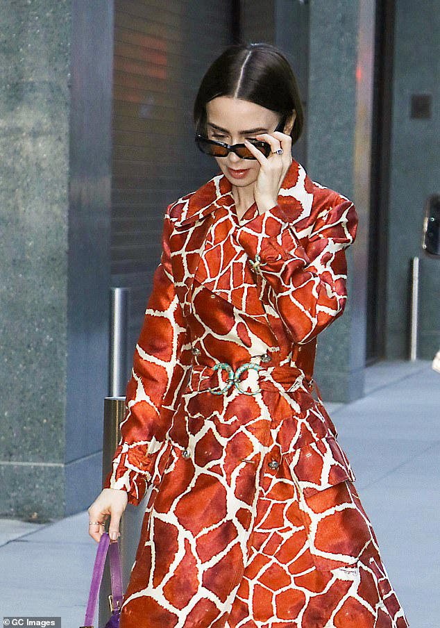 Lily Collins cuts a stylish figure in a vintage Roberto Cavalli coat as ...