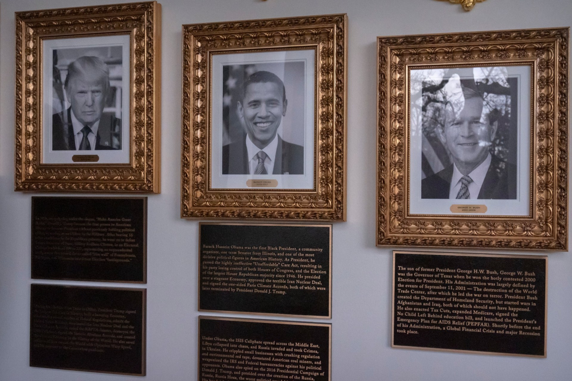 Trump adds critical plaques under Obama and Biden pics