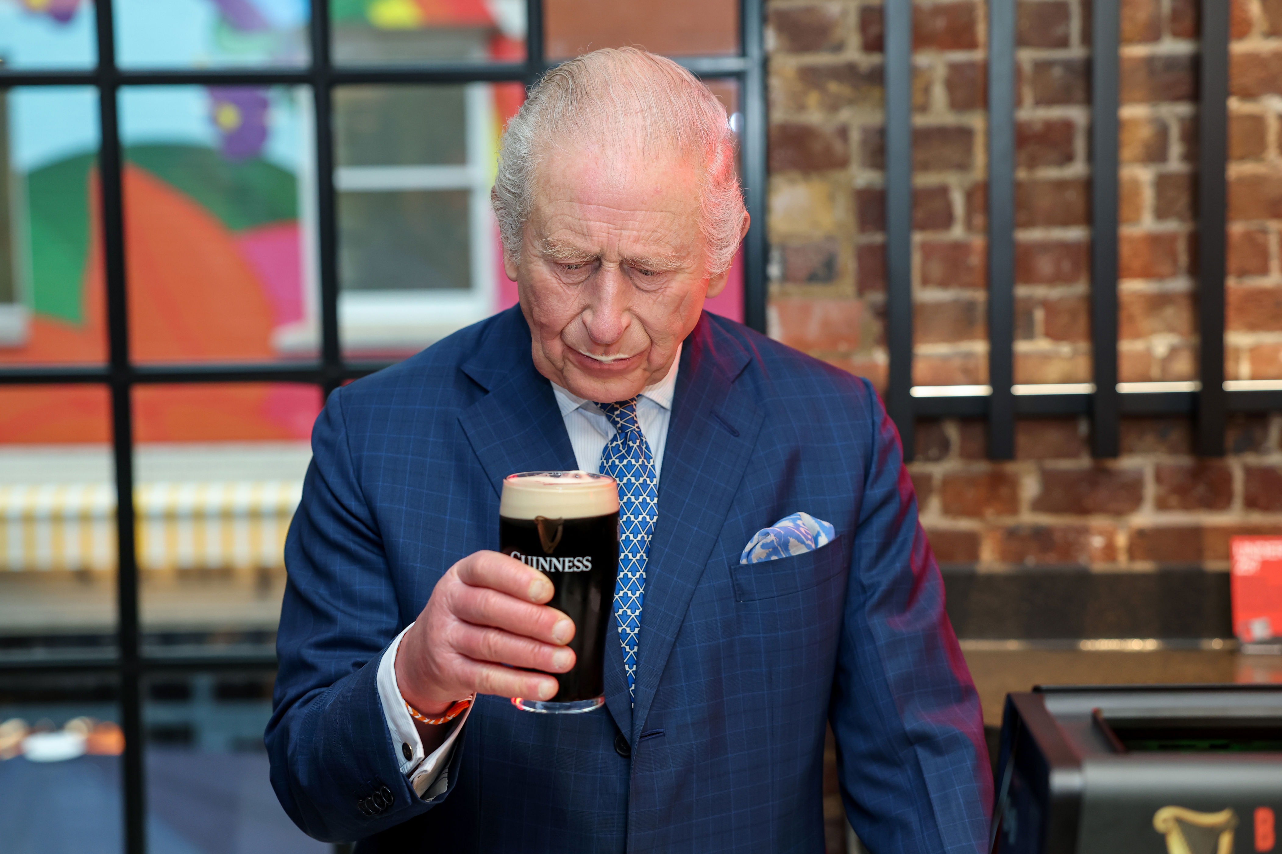 Charles plays barman and pulls the 'perfect' pint of Guinness
