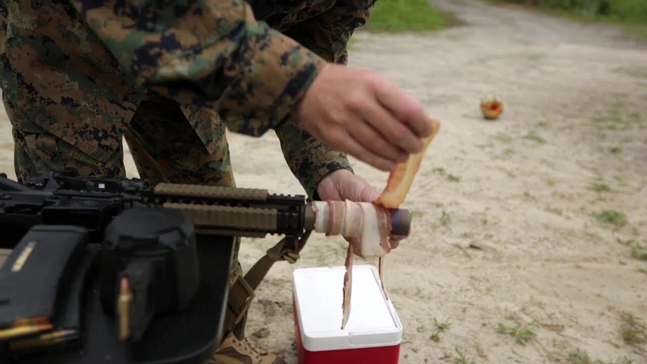 Marine Corps gunner • cooks bacon on a rifle silencer