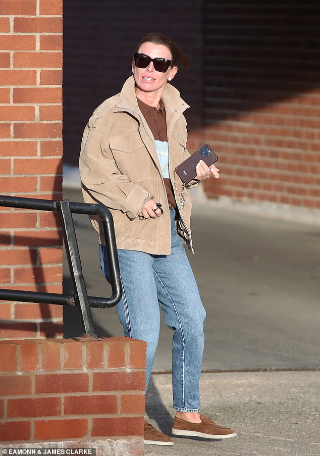 Coleen Rooney looks effortlessly chic in beige suede jacket as she runs ...