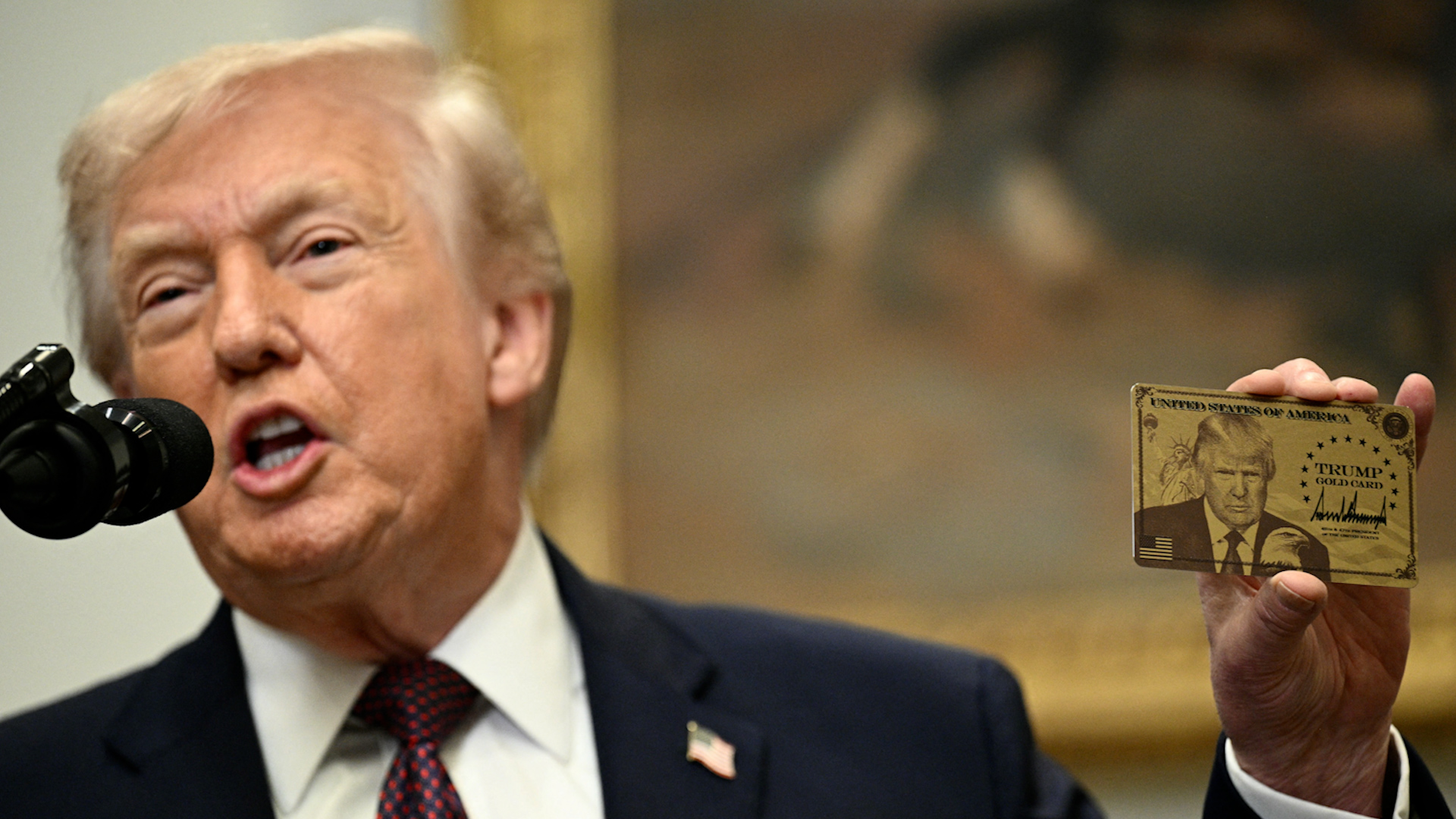 Trump shows off 'gold card' as sales top $1 billion