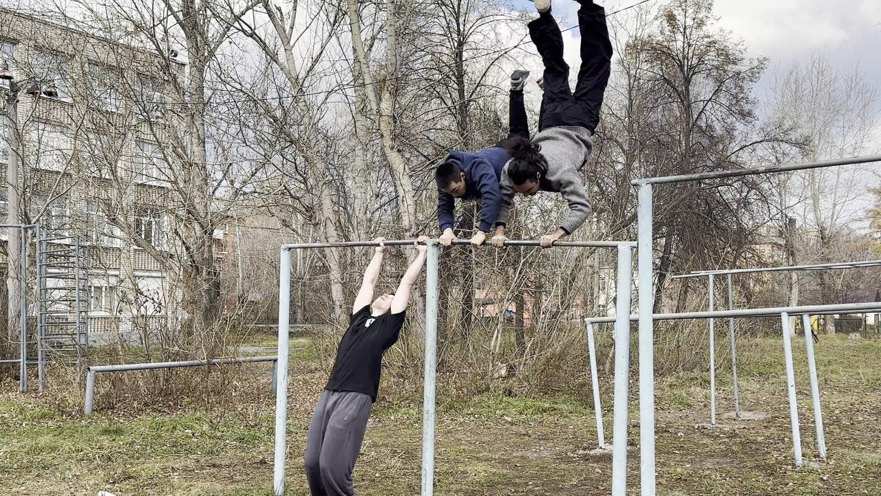 Three person helicopter on horizontal bar