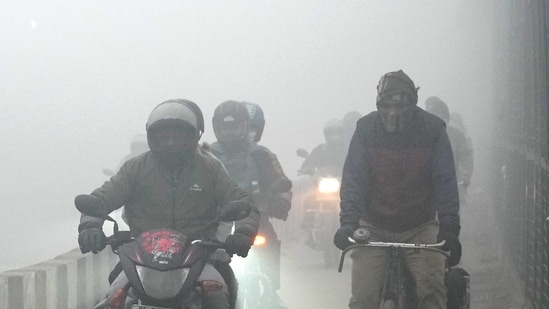 Watch: Commuters ride cars, bikes braving zero visibility as dense fog ...