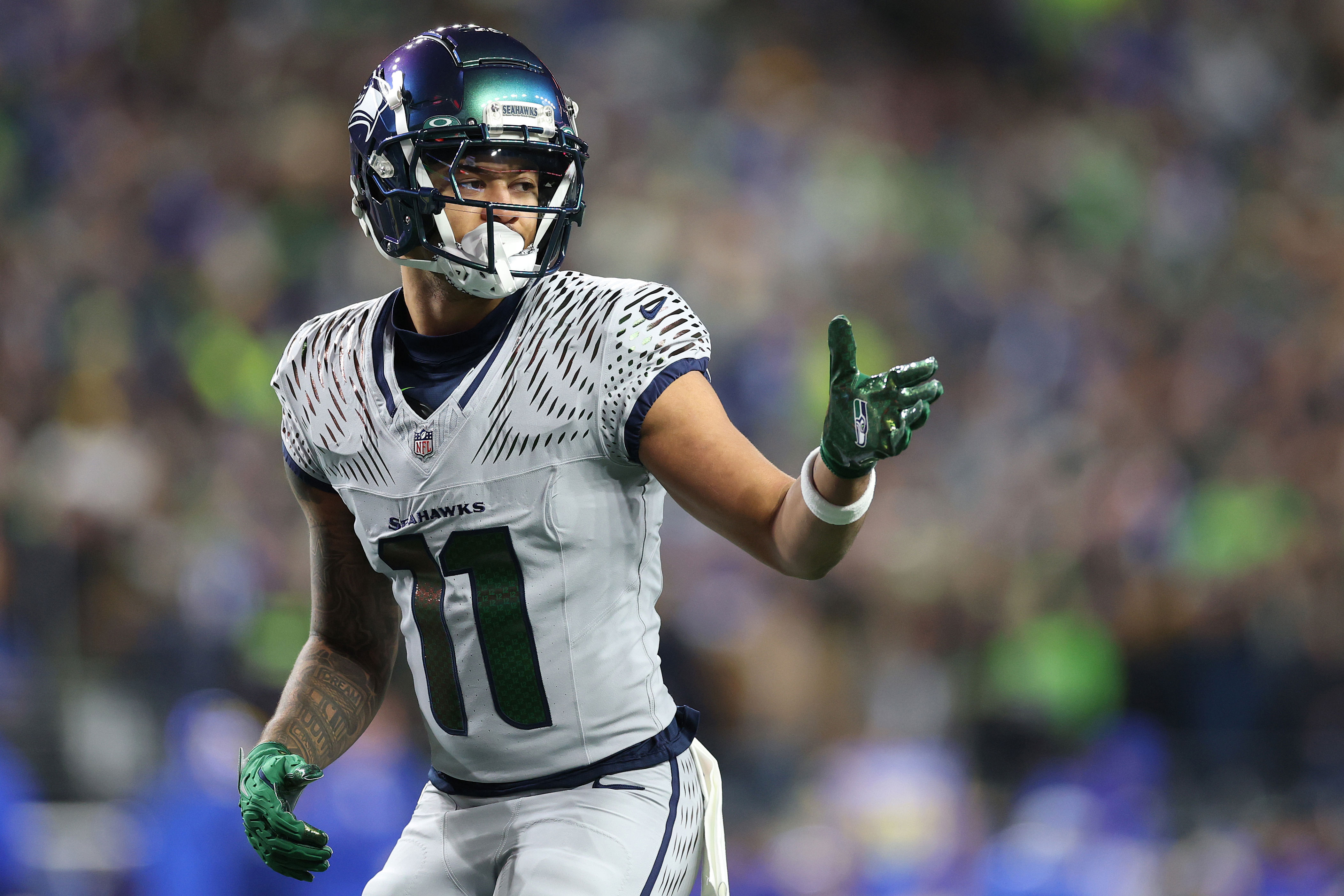 Jaxon Smith-Njigba celebrates in Lumen Field stands after Seahawks win