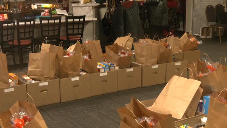 Volunteers at local American Legion post pack 70 holiday food baskets