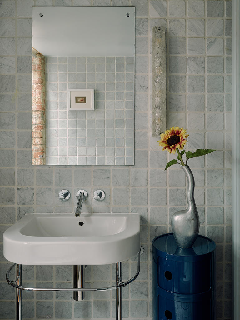 Lilac paint and a powder blue sofa soften up this industrial London loft