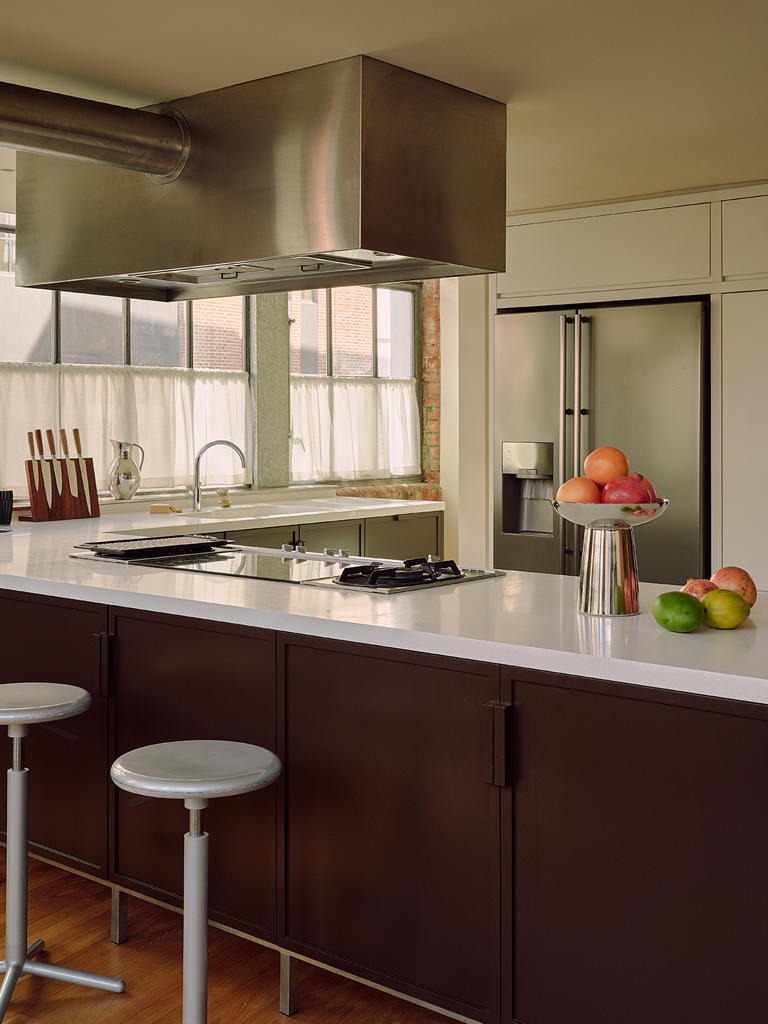 Lilac paint and a powder blue sofa soften up this industrial London loft