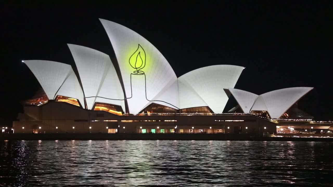 Sydney Opera House is lit up with candle one week after Bondi ISIS attack
