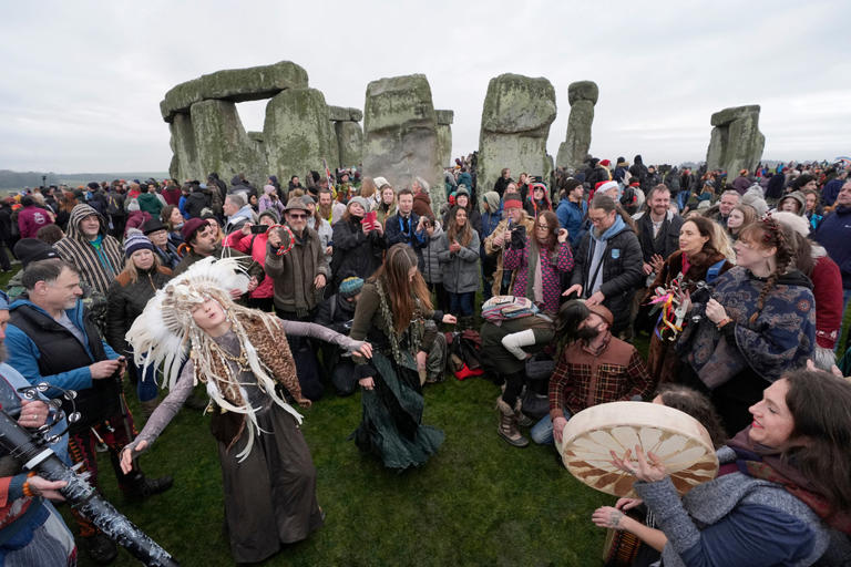 Thousands cheer as the sun rises on winter solstice at Stonehenge
