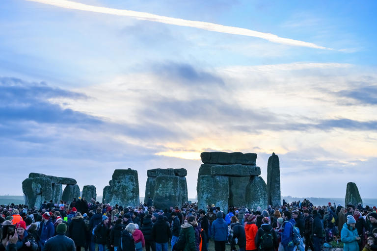 Thousands cheer as the sun rises on winter solstice at Stonehenge