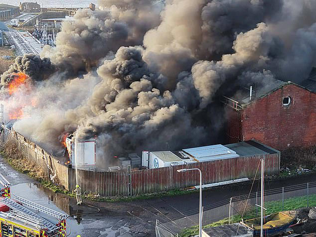 Moment massive fire rips through HGVs and trailers at docks sending ...