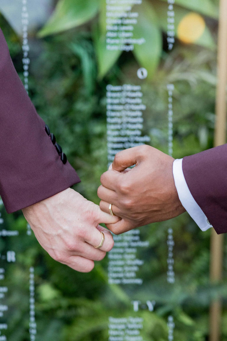 These dapper grooms wore burgundy tuxedos to their “tropical disco” wedding