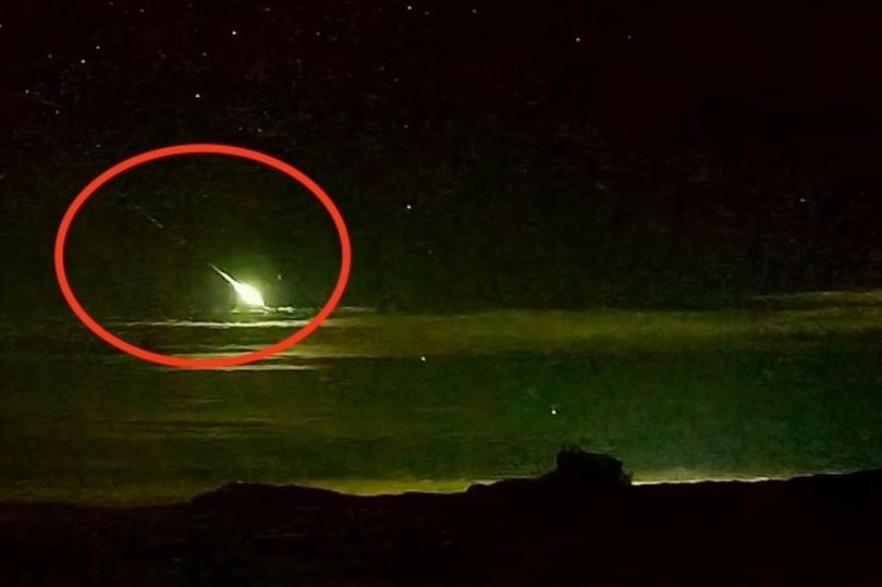 Bright green meteor crashes through atmosphere and lights up clouds in ...