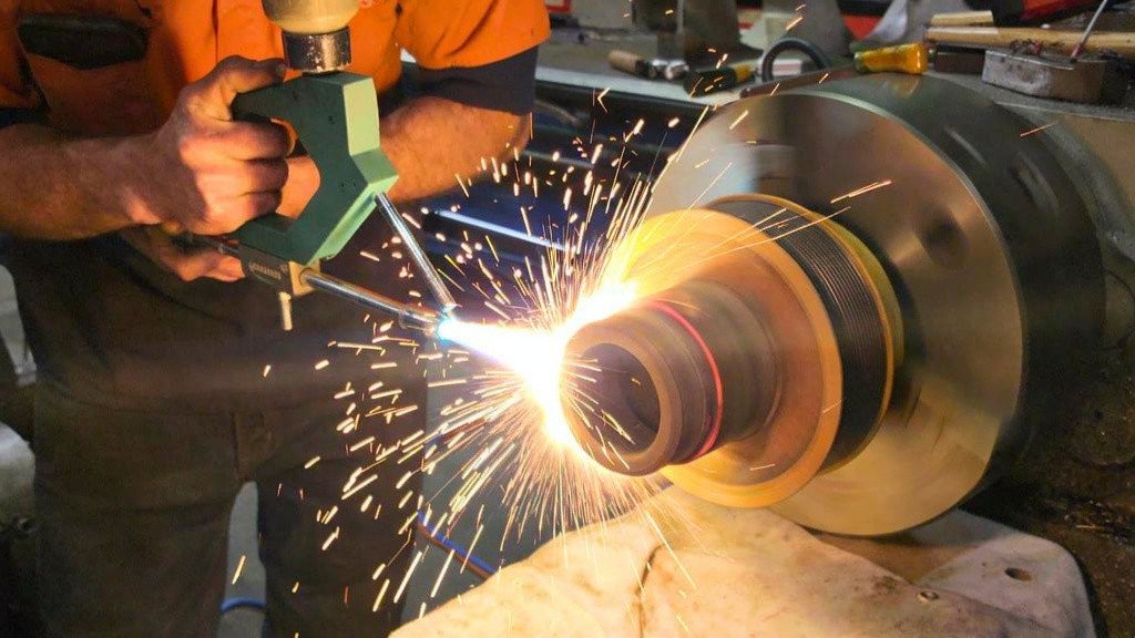 Metal spray repair on a CAT crank pulley