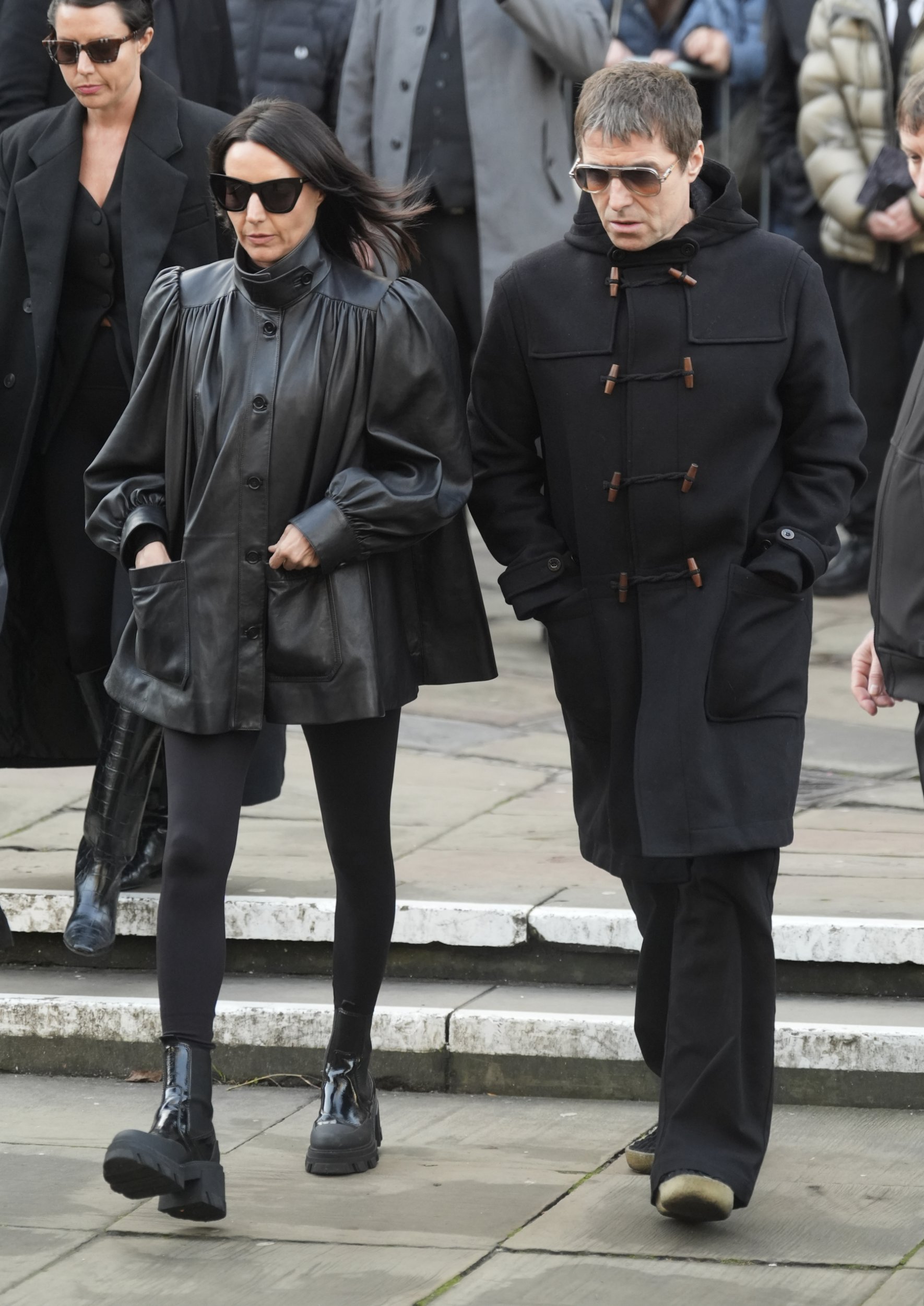 Liam Gallagher carries Gary Mounfield's coffin