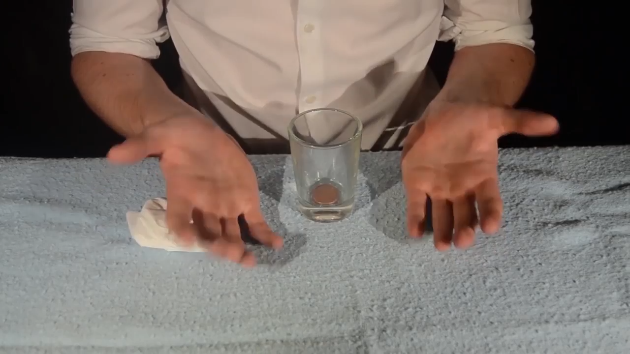 How a coin passes through a solid table in plain sight