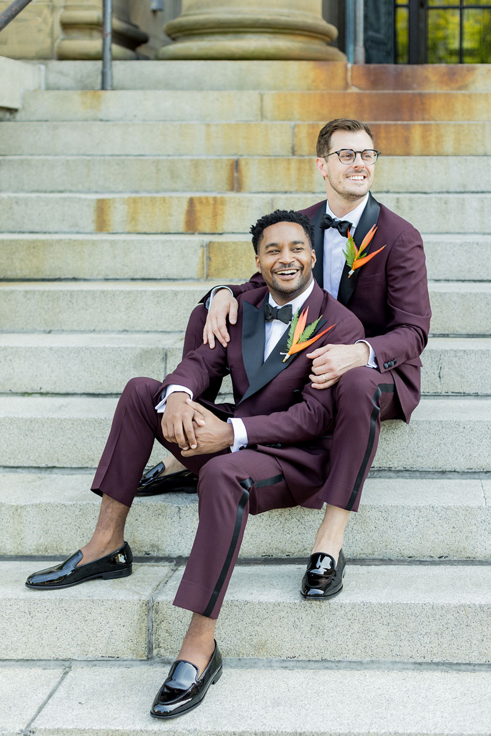 These dapper grooms wore burgundy tuxedos to their “tropical disco” wedding