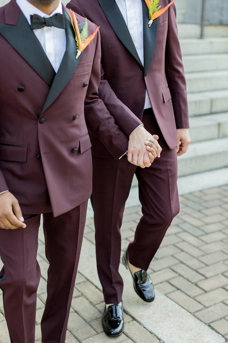 These dapper grooms wore burgundy tuxedos to their “tropical disco” wedding