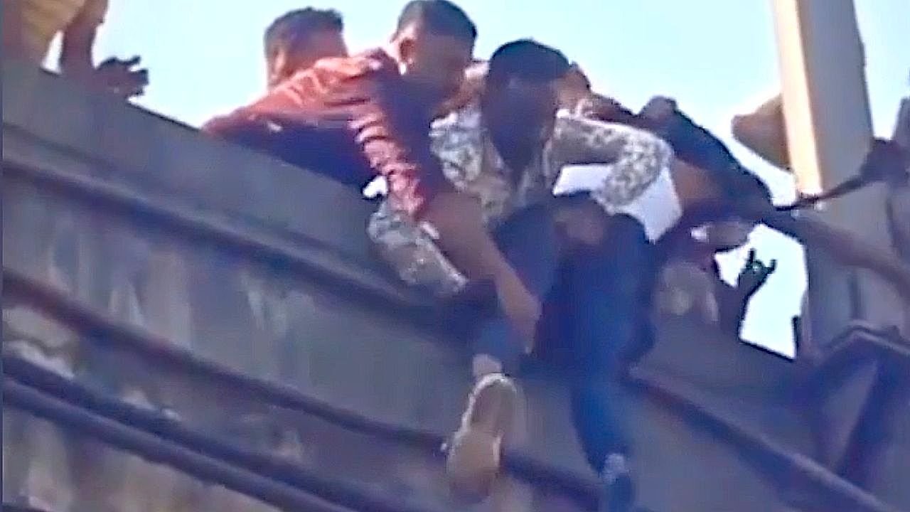 Man left hanging over bridge survives after dramatic roadside rescue