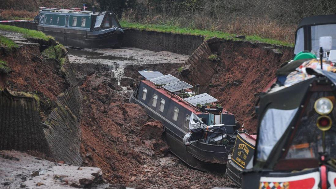 In pictures: Canal bursts to leave giant hole
