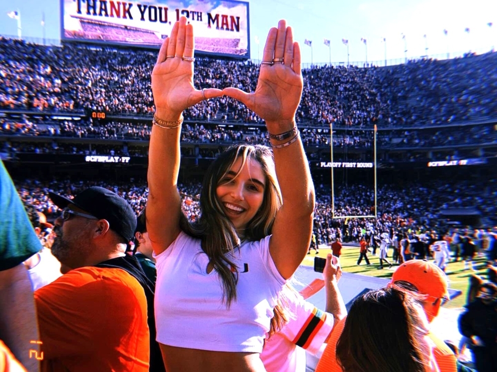 Fans go wild after porn star spotted cheering during NCAA football ...