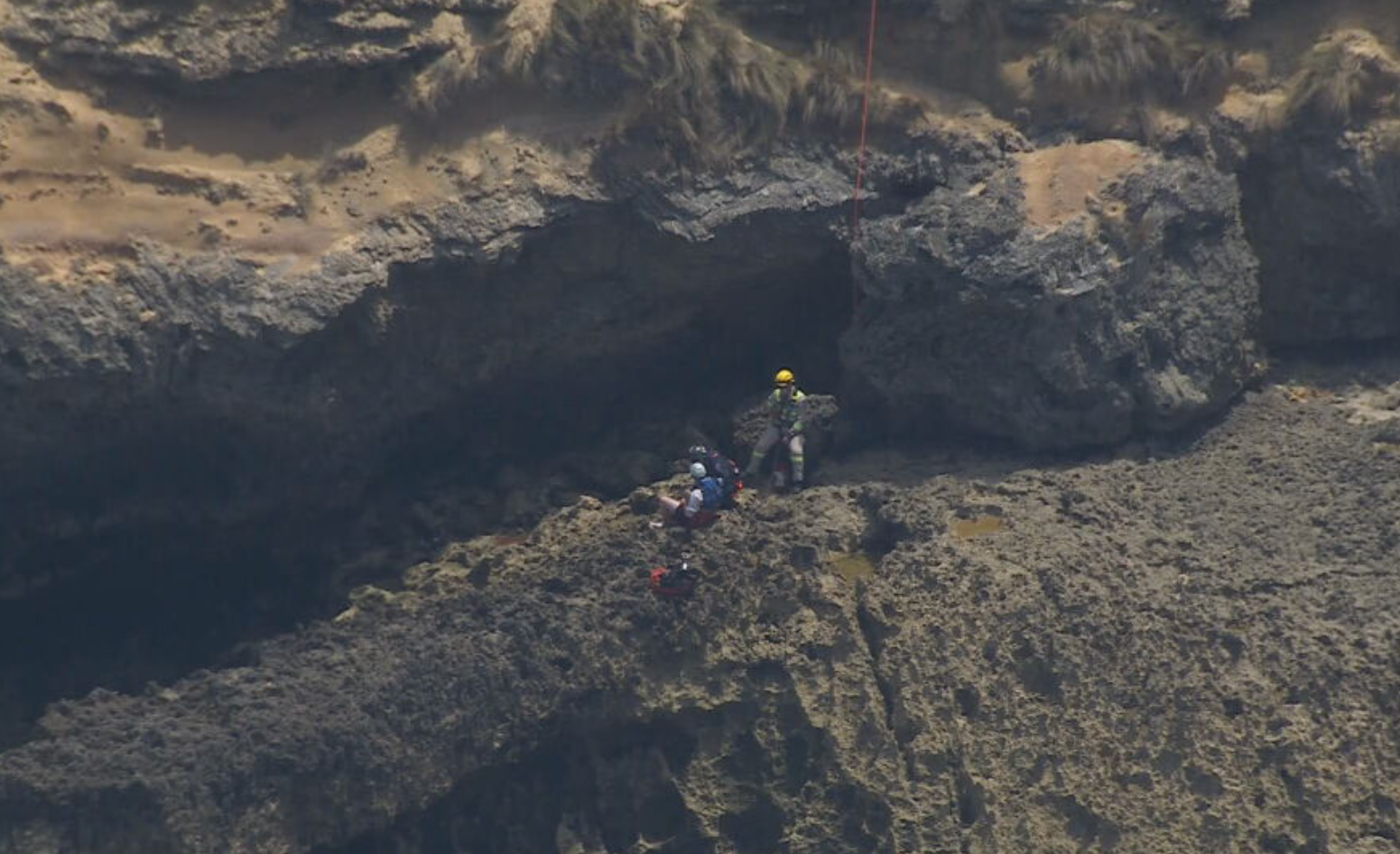 Teen winched to safety after plunging metres from cliff in tourist hotspot
