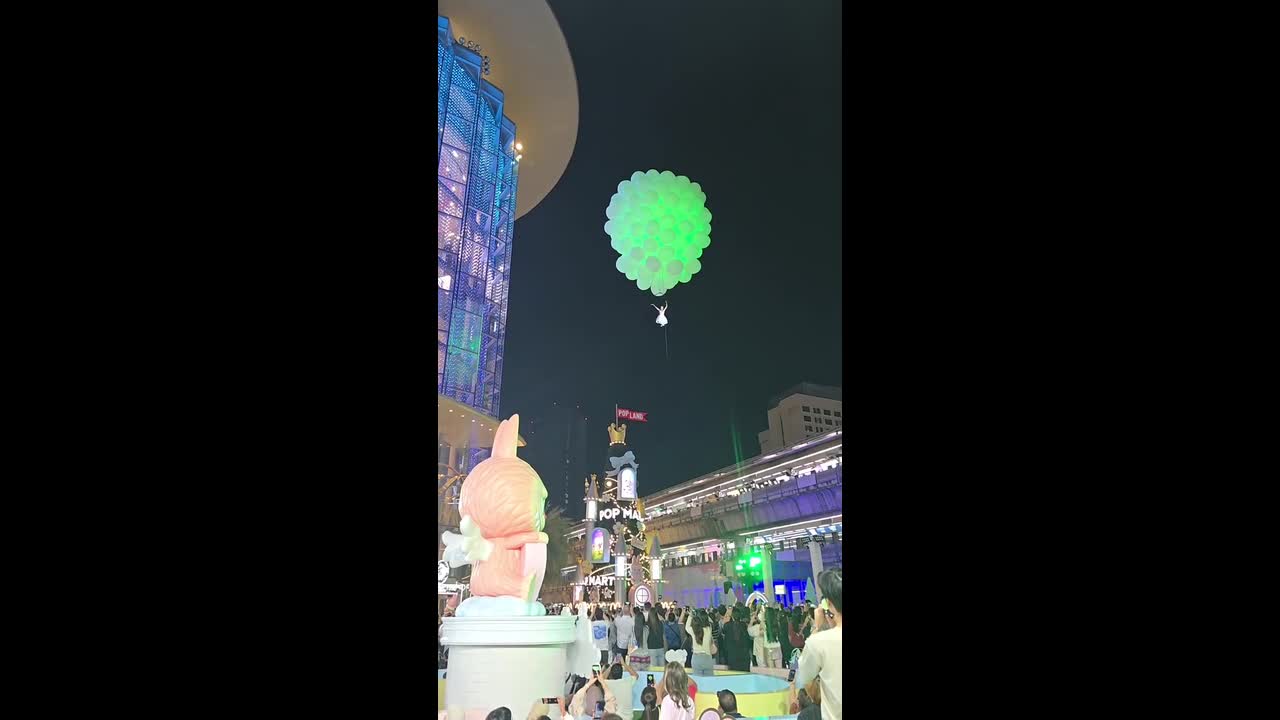 Performer dangles from balloons for 'space ballet' performance