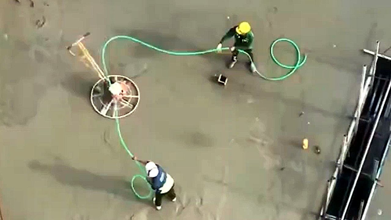 Workers try to 'wrangle' out-of-control powered trowel