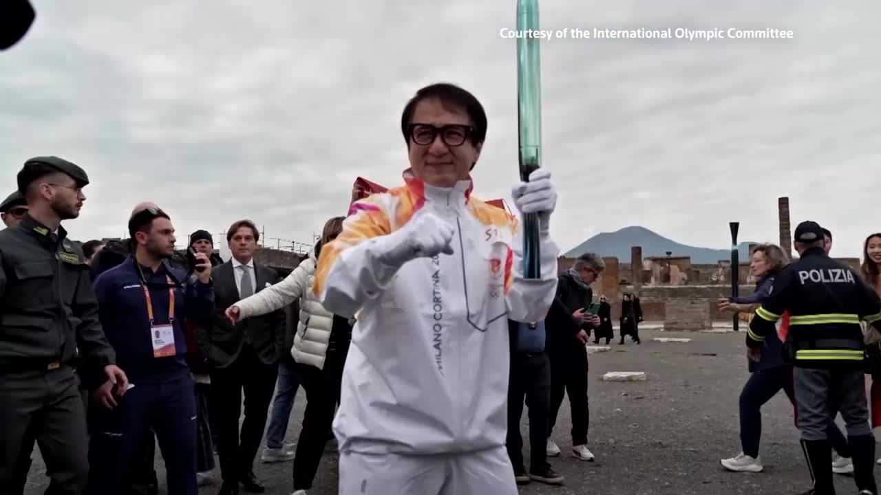 Jackie Chan carries the Olympic torch through the ruins of Pompeii