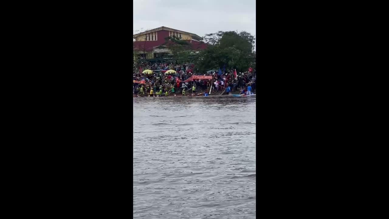 Rowers fight each other with paddles at boat racing festival in Vietnam