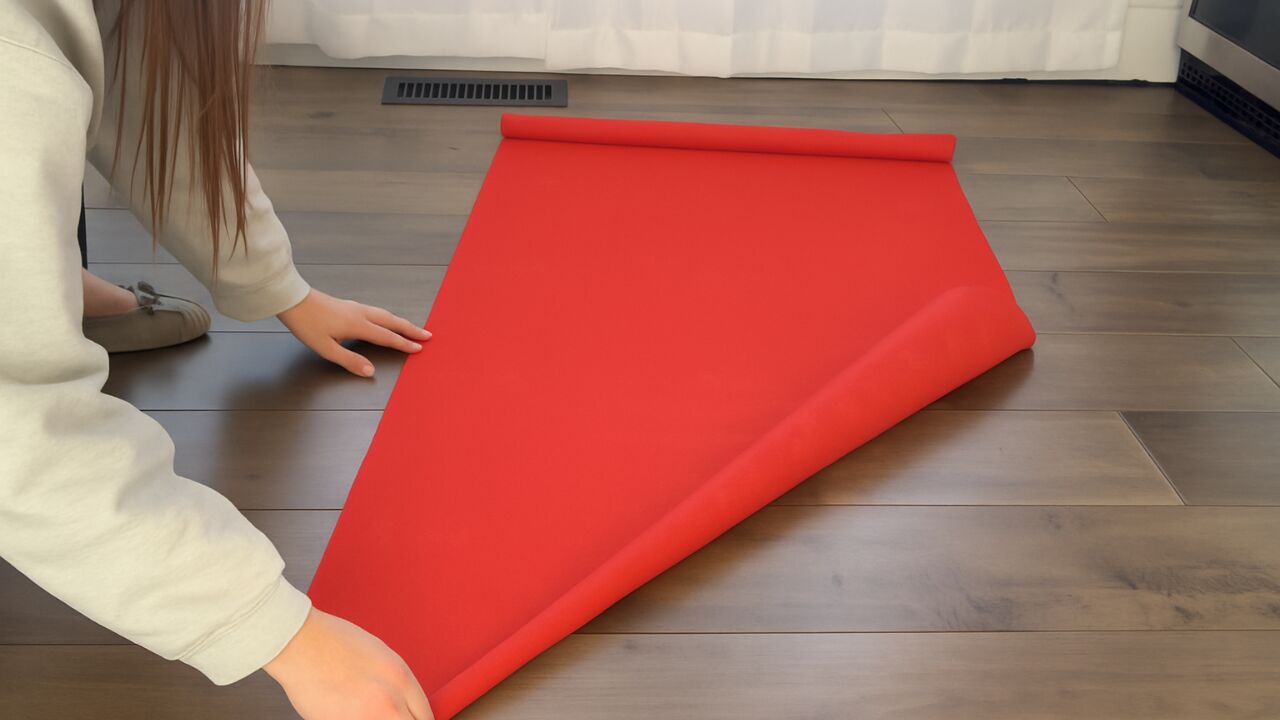 She lays wrapping paper on her kitchen floor for this genius idea!