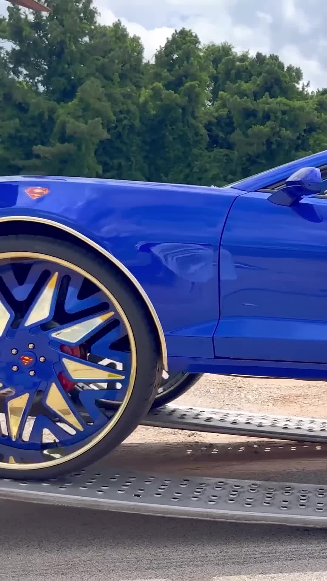 Chevy Camaro on 34’s Forgiatos getting off transport