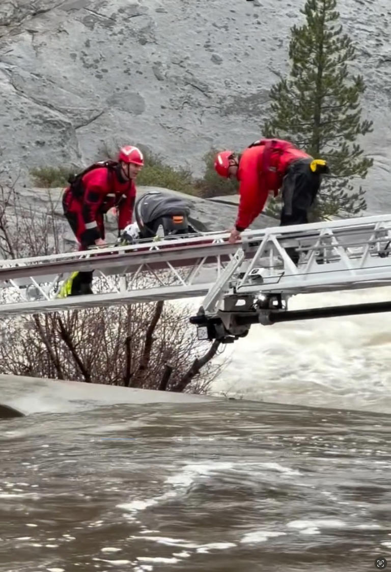 Heroic rescuers slide baby in car seat across raging floodwaters to ...