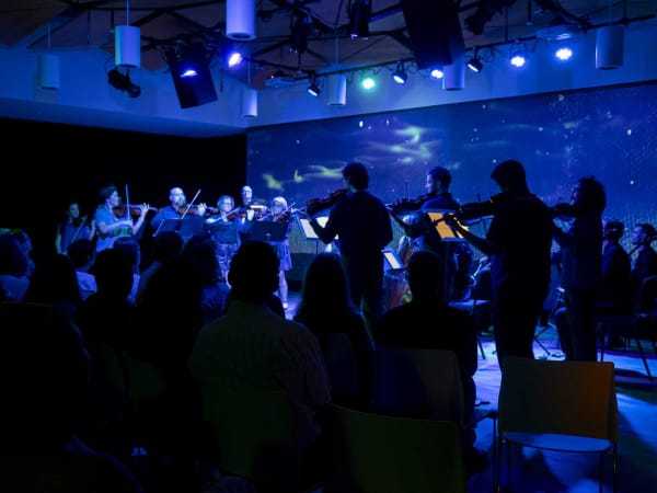 Austin groups collaborate on musical piece composed live by hand signals