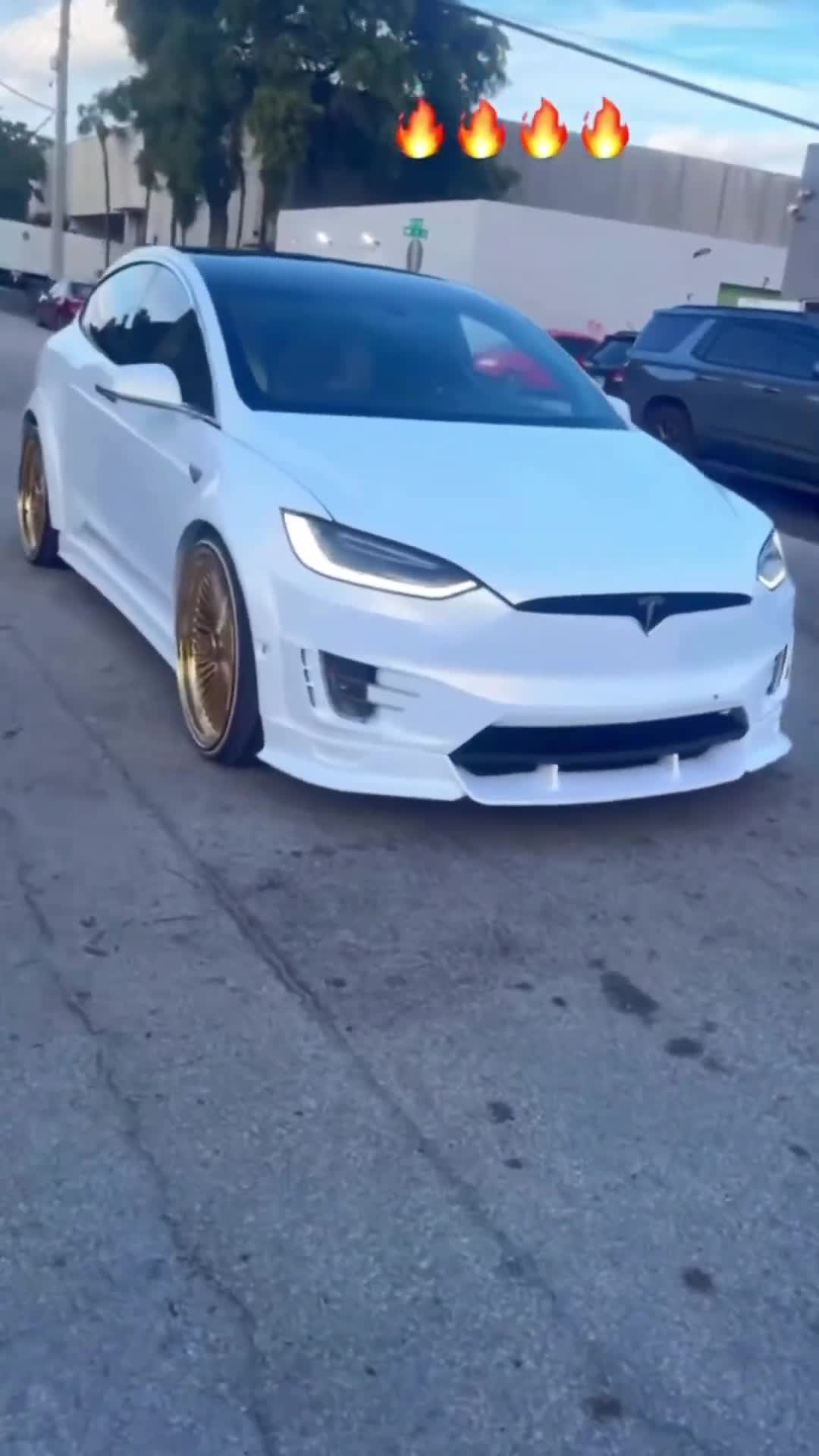 Widebody pearl white Tesla Model X on gold 24’s Daytons