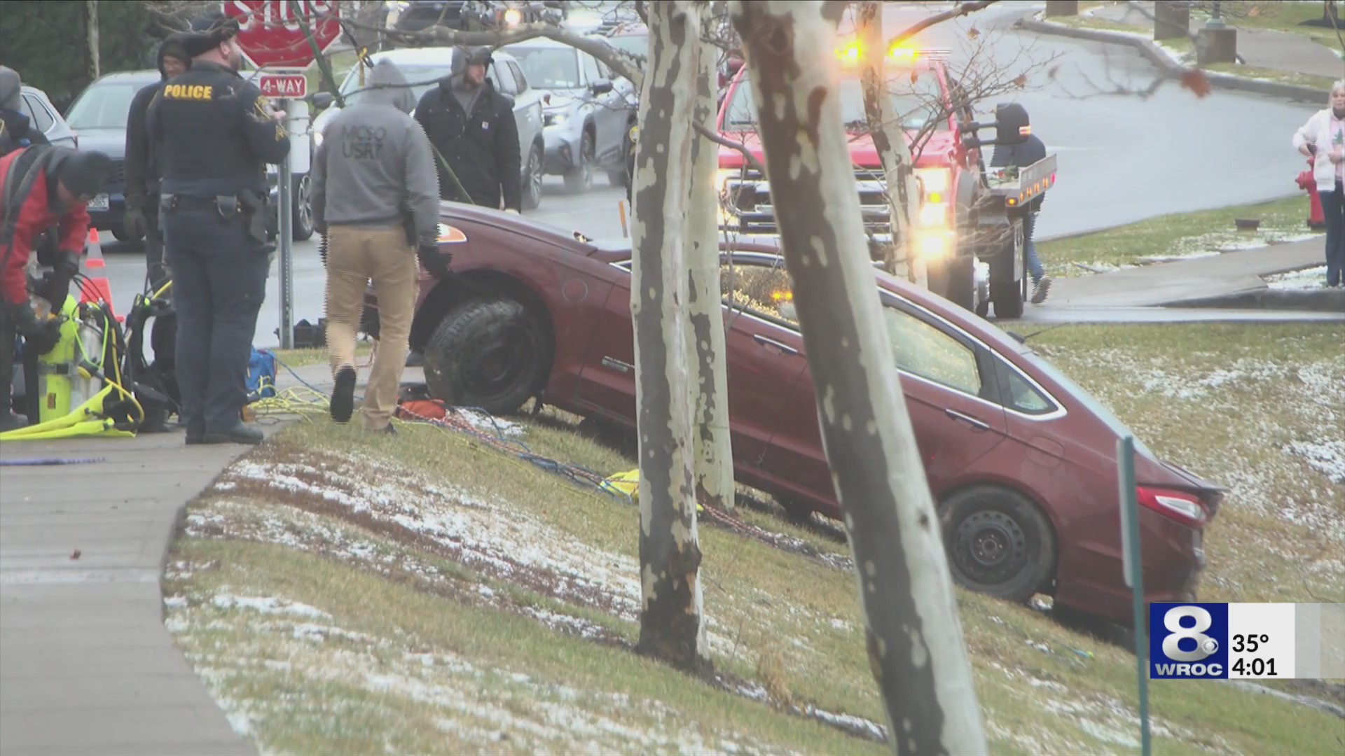 Woman in stable condition after car goes into Webster pond