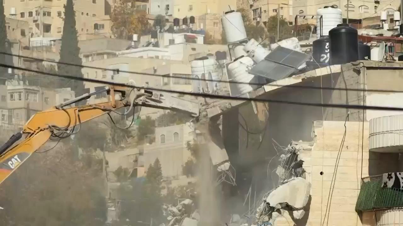 Palestinians watch in shock as Israel demolishes block of flats in East ...