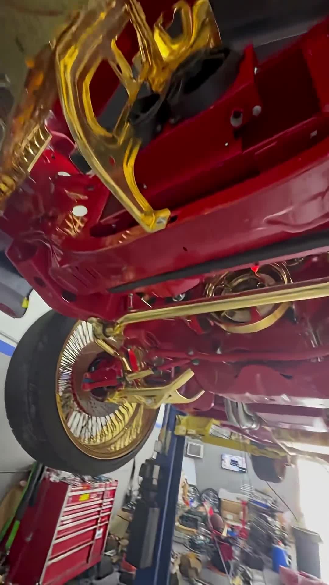 Red 71 Chevy vert on gold 24’s Daytons in the lab at Blue Magic Built