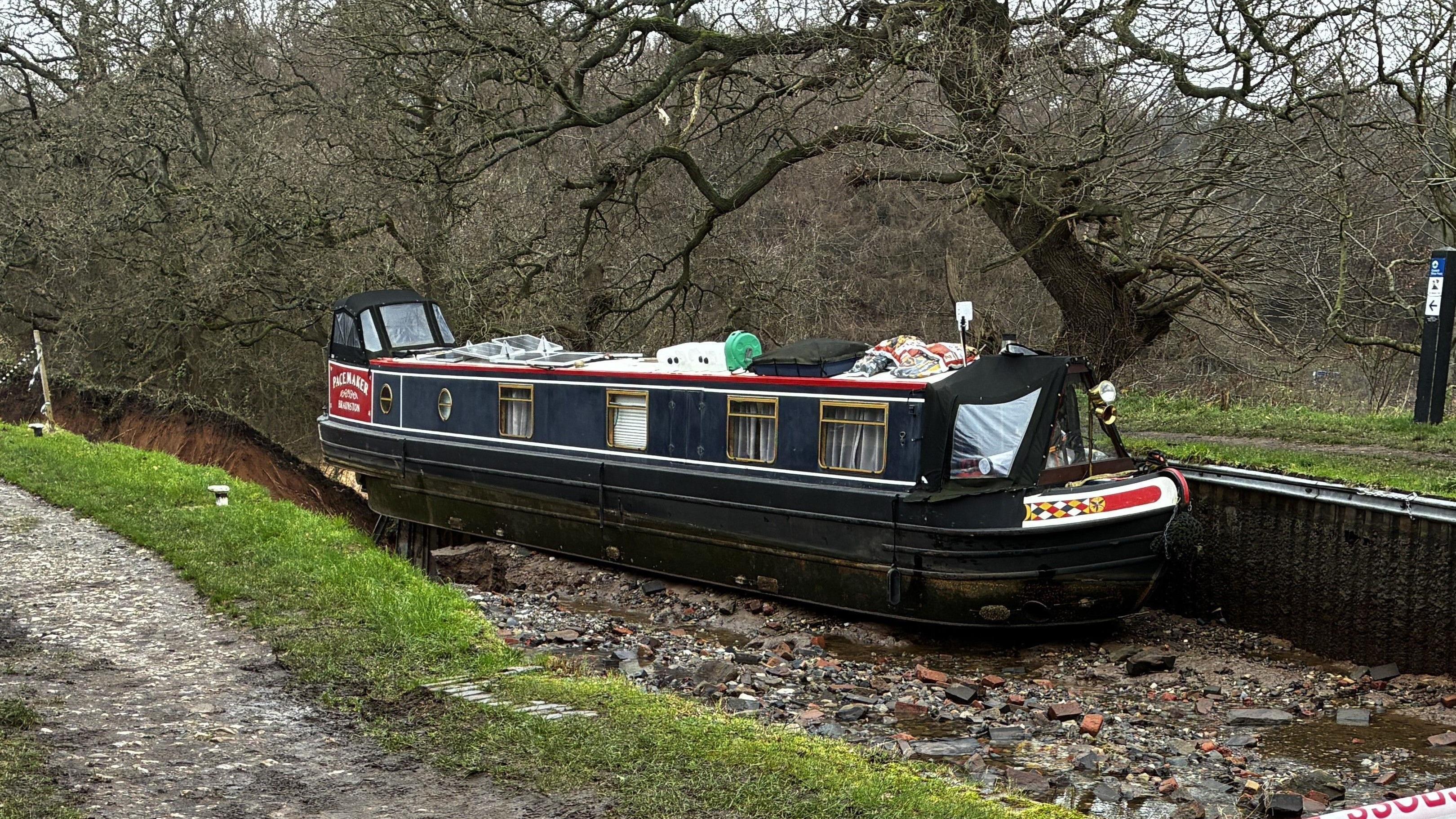 Boat stranded on canal hole edge pulled to safety