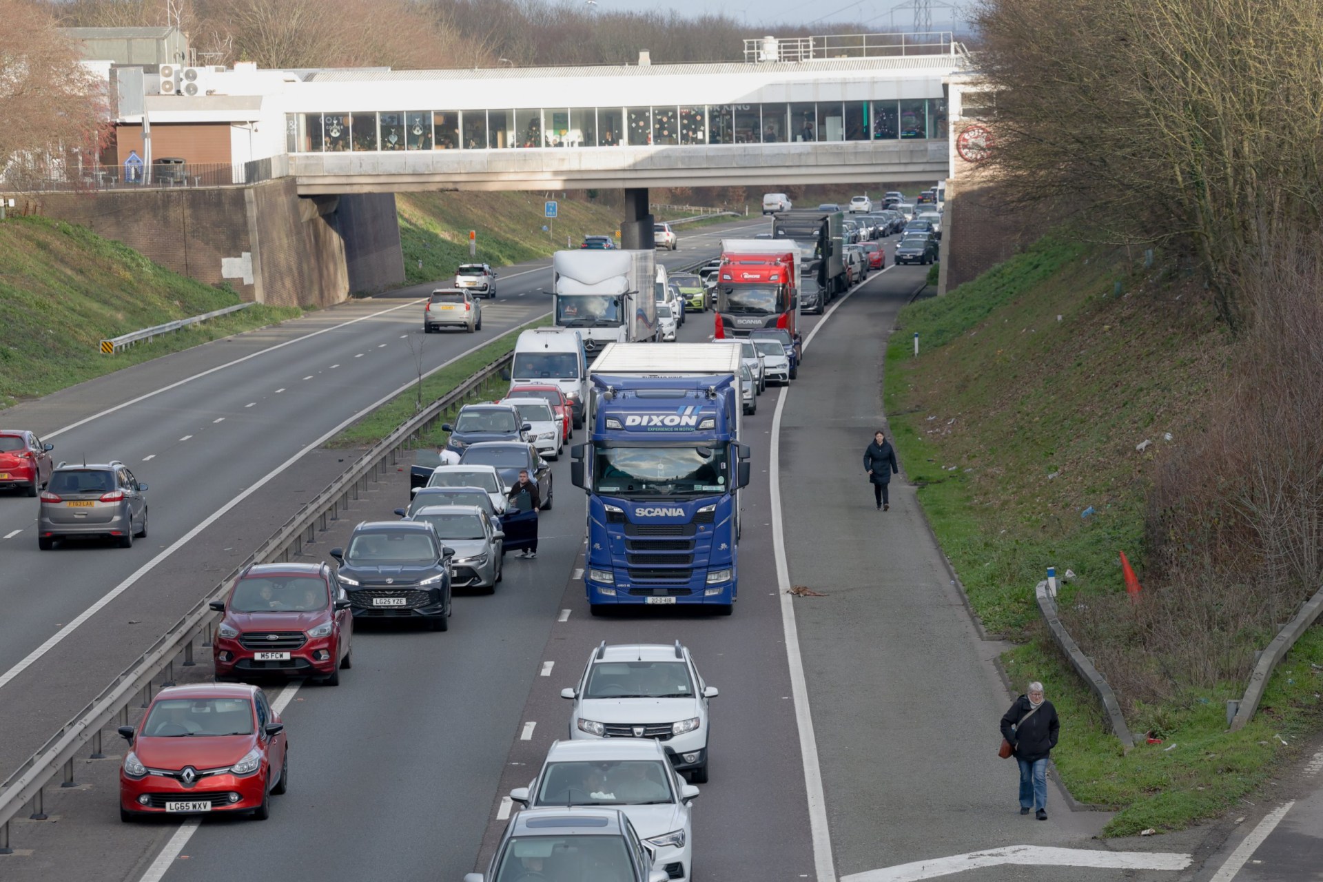 Drivers walk along the motorway after serious crash