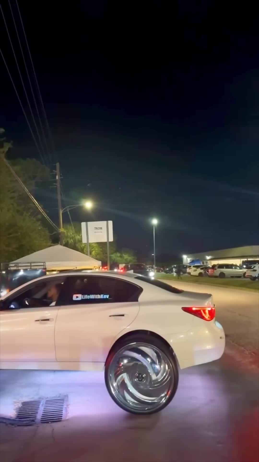 White Infiniti Q50 on 30” DUB skates