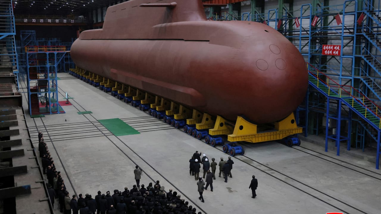 North Korea's Kim Jong Un views submarine construction, oversees ...